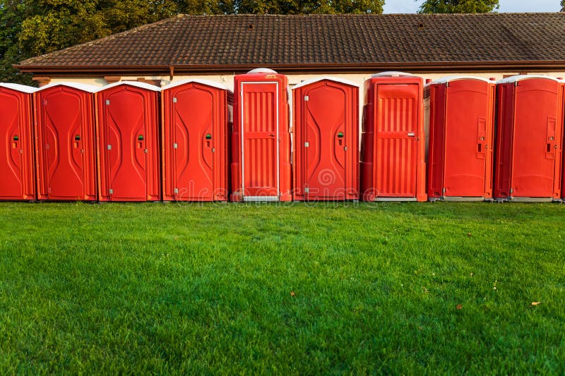 Portable Plastic Red Toilets in a Park - Mobile Sanitary System Stock ...