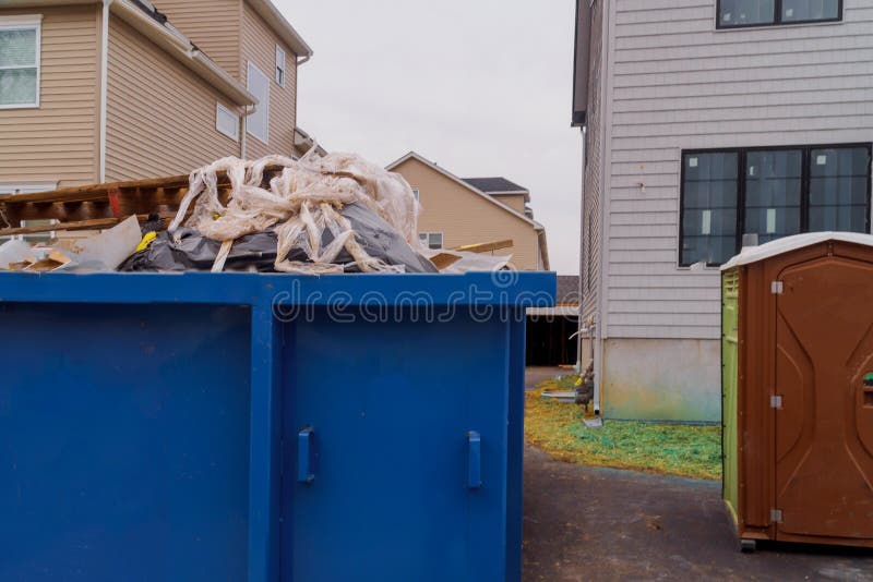 Portable Restroom on a Dumpsters Being Full with Garbage New House ...