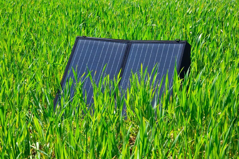 Portable Solar Panel Standing in Green Grass Field Under Sunlight ...