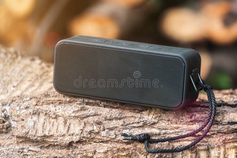 Portable Wireless Speaker for Listening To Music on a Log Stock Image ...