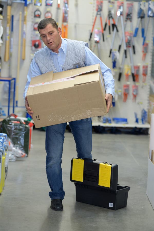 Porter Carrying Boxes in Warehouse Stock Photo - Image of shelves ...
