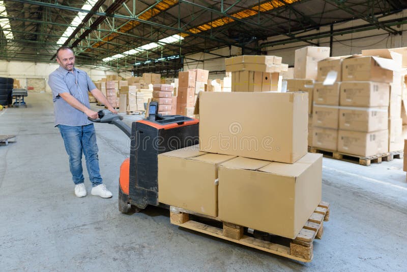 Porter Carrying Boxes in Warehouse Stock Photo - Image of shipping ...