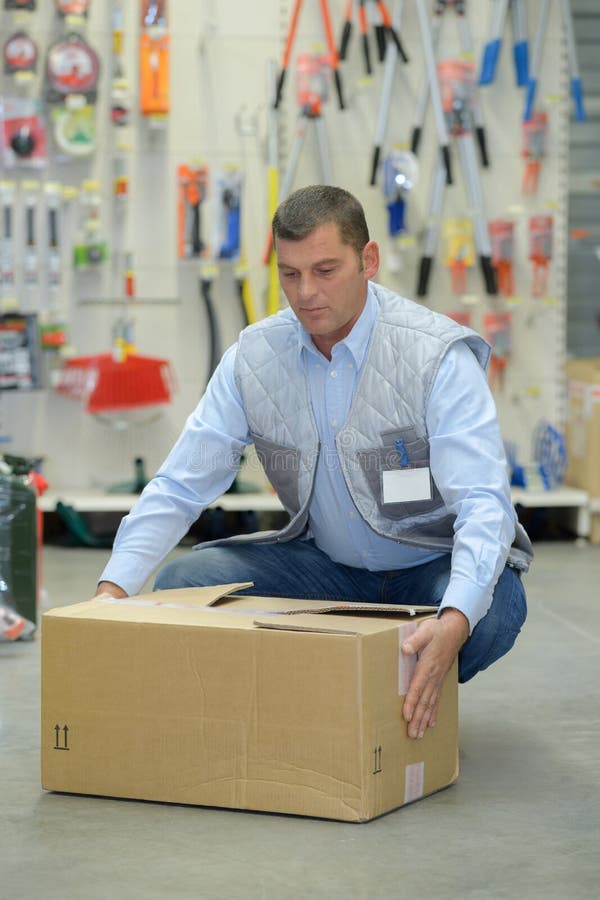 Porter Carrying Boxes in Warehouse Stock Photo - Image of store ...