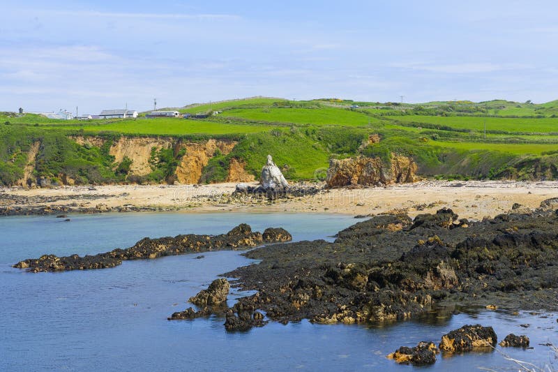 Porth Padrig Beach and the White Lady Quartzite Sea Stack Stock Image ...