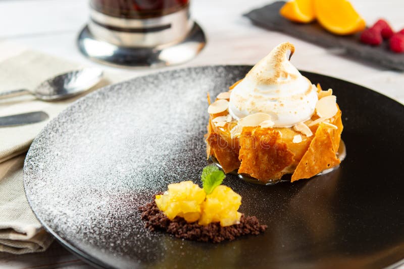 A Portion of Apple Pie with Cream on a Black Plate. Charlotte Dessert ...