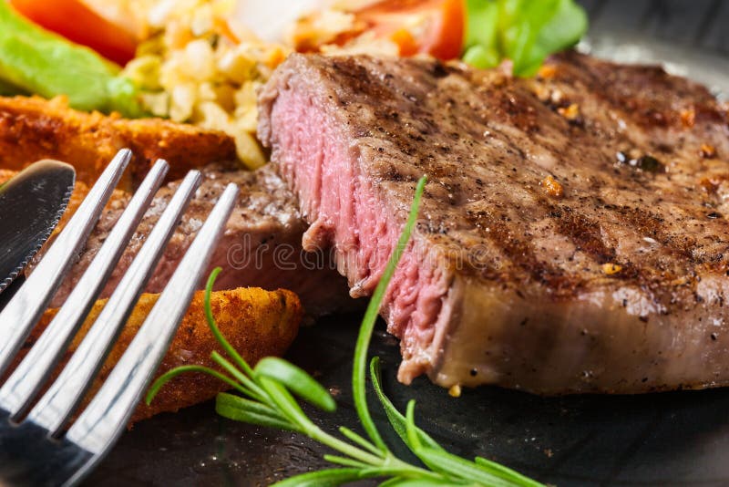 Portion of Beef Steak Served with Roast Potatoes Stock Photo - Image of ...