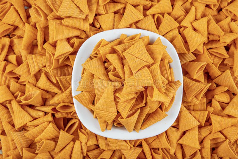 Portion of Cone Shaped Snack Tornado Shaped Crackers. Yellow Spicy ...
