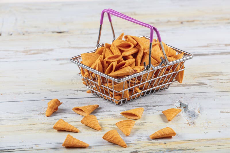 Portion of Cone Shaped Snack Tornado Shaped Crackers. Yellow Spicy ...