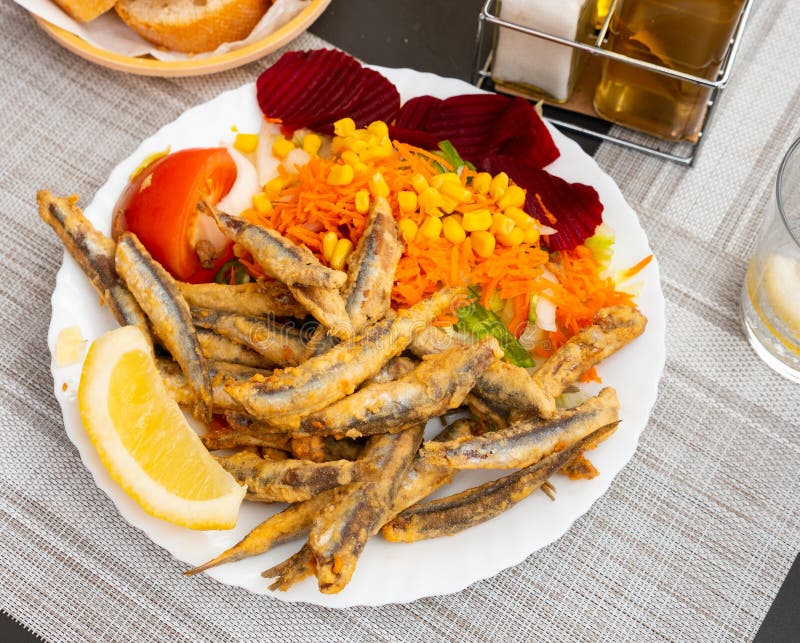 Portion of Fried Fish Served with Lemon and Vegetables, Typical Dish of ...