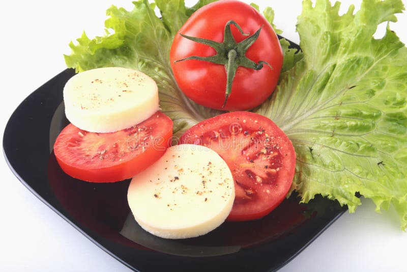Portion of Mozzarella with Tomatoes, Lettuce Leaf and Balsamic Dressing ...