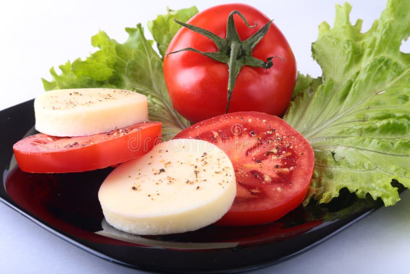 Portion of Mozzarella with Tomatoes, Lettuce Leaf and Balsamic Dressing ...
