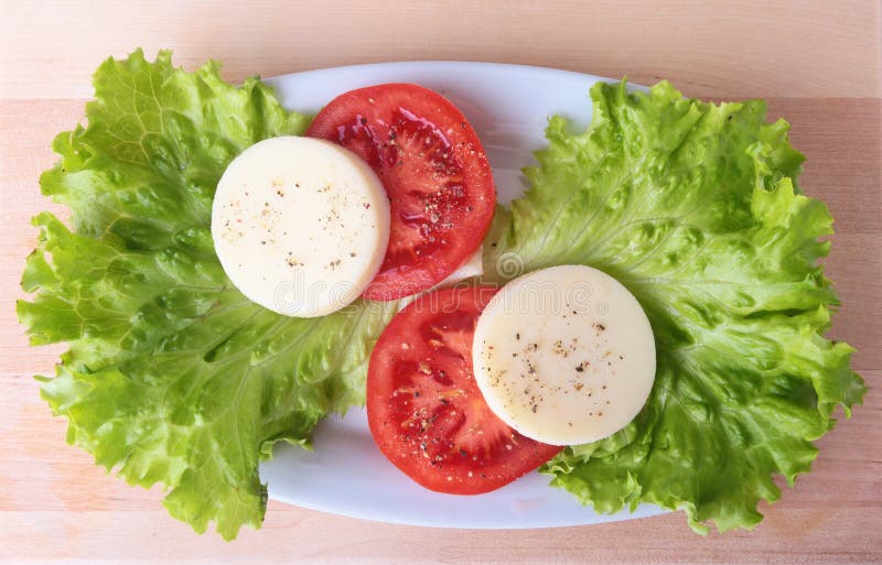 Portion of Mozzarella with Tomatoes, Lettuce Leaf and Balsamic Dressing ...