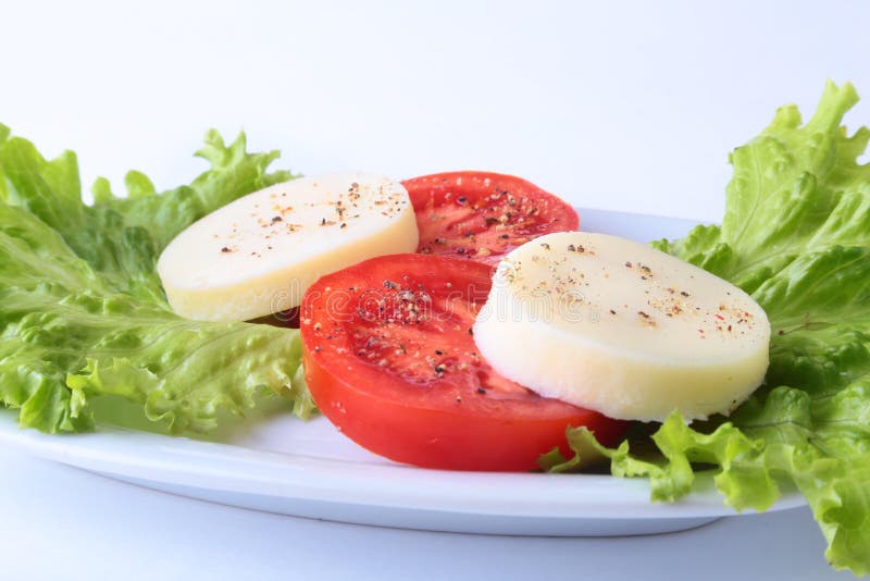 Portion of Mozzarella with Tomatoes, Lettuce Leaf and Balsamic Dressing ...