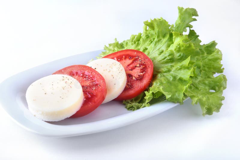 Portion of Mozzarella with Tomatoes, Lettuce Leaf and Balsamic Dressing ...