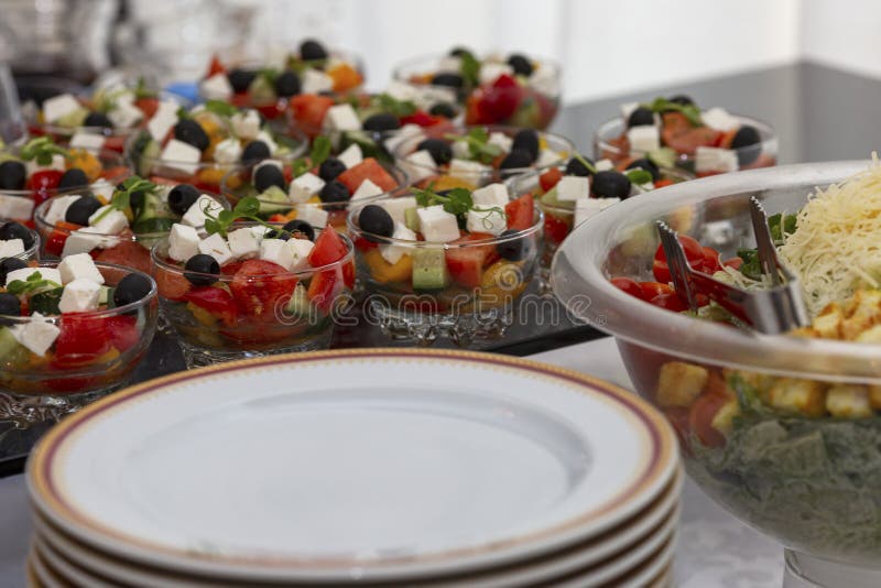 Portioned Salads and Empty Plates on the Buffet Table. Beautiful ...