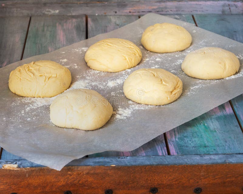 Portions of Dough Lie on a Deep Wooden Table Stock Photo - Image of ...