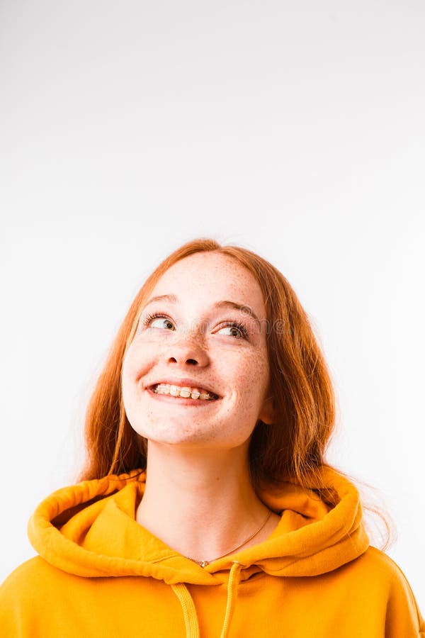 Portrait Of An Emotional Red Haired Girl With Freckles And Braces On A