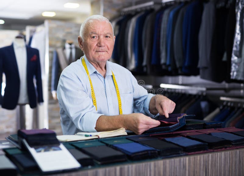 Portrait of an Accomplished Tailor with Samples of Fabric in Atelier ...