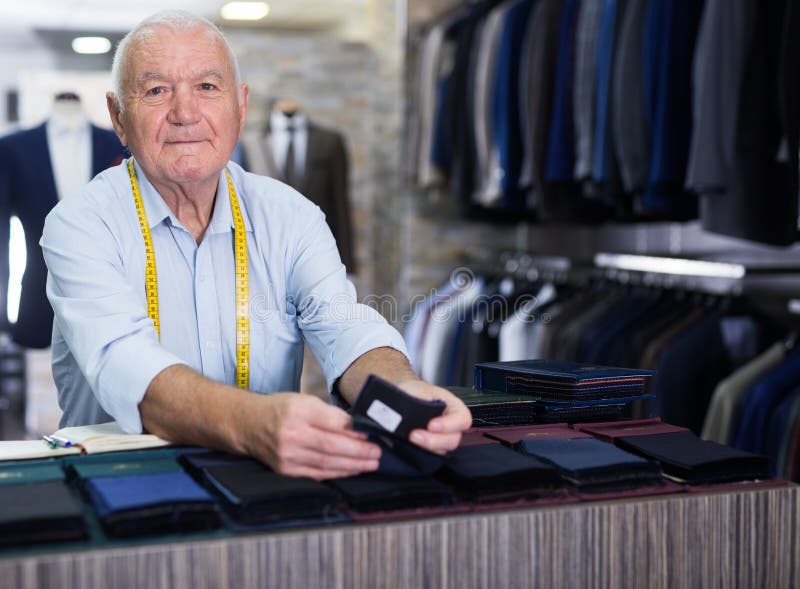 Portrait of an Accomplished Tailor with Samples of Fabric in Atelier ...