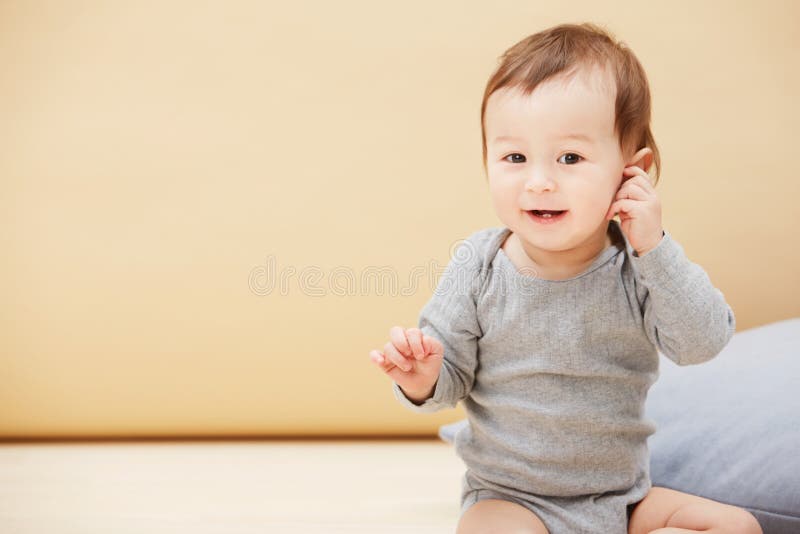 Hes a Happy Little Guy. Portrait of an Adorable Baby Boy Sitting on the ... Hes a Happy Little Guy. Portrait of an Adorable Baby Boy Sitting on the ...