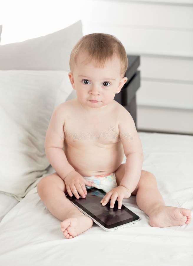 Portrait of Adorable Baby Boy Using Digital Tablet on Bed Stock Image ...
