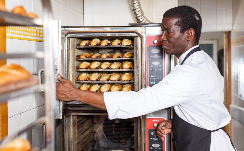 Baker Controlling Process of Baking Bread in Oven Stock Image - Image ...