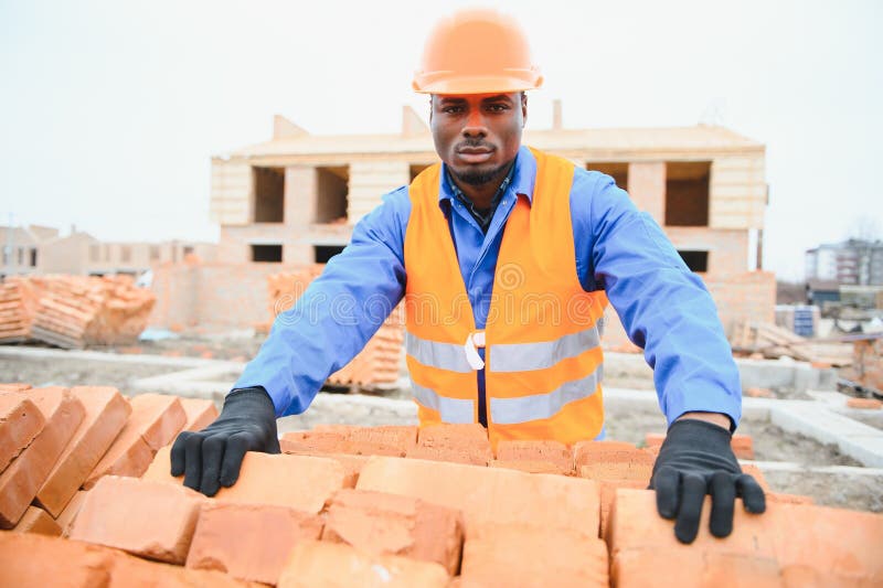 Portrait of an African American Construction Worker. a Builder Builds a ...