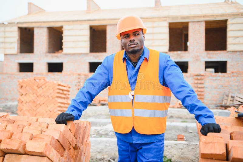 Portrait of an African American Construction Worker. a Builder Builds a ...