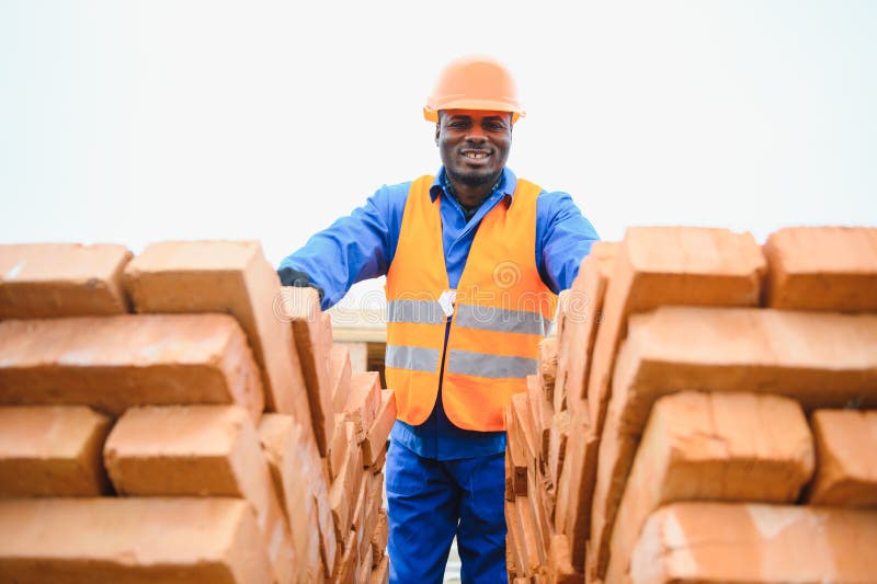 Portrait of an African American Construction Worker. a Builder Builds a ...