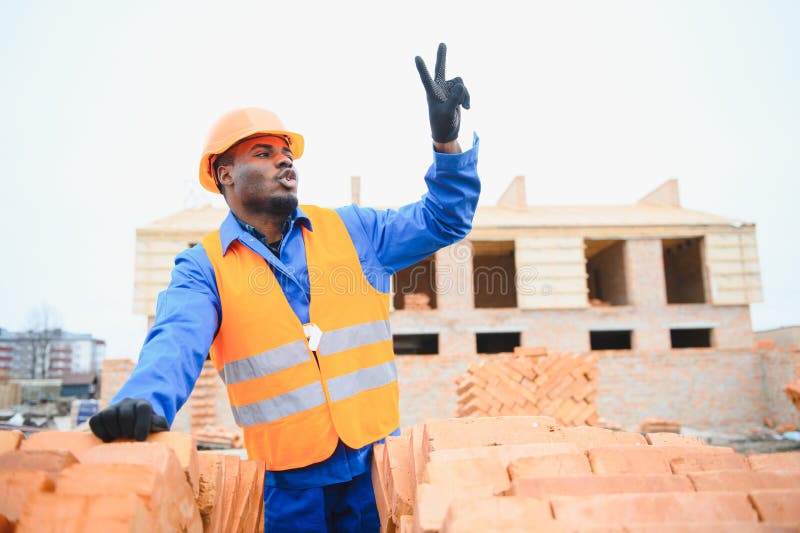 Portrait of an African American Construction Worker. a Builder Builds a ...