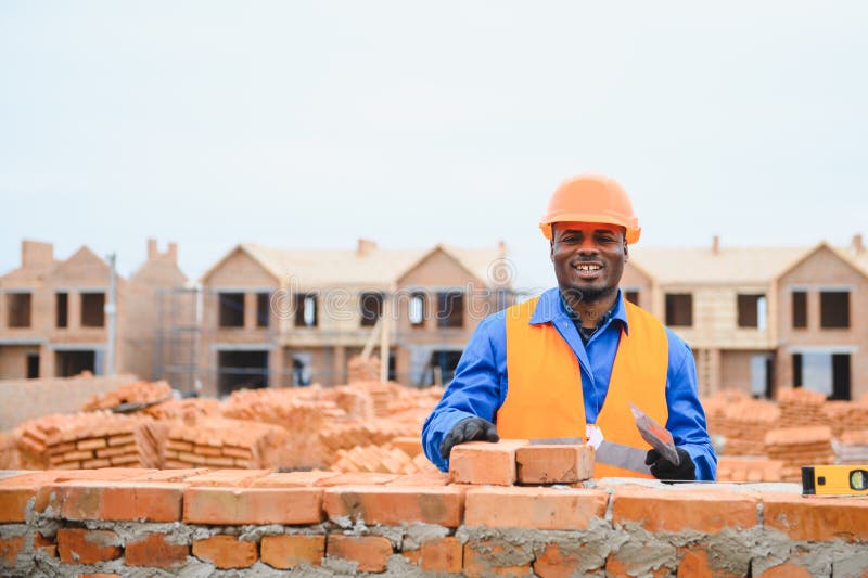Portrait of an African American Construction Worker. a Builder Builds a ...
