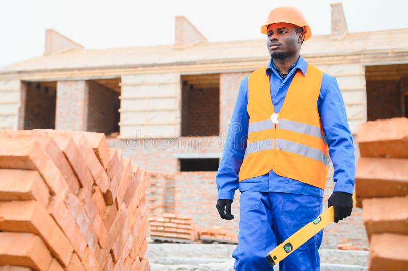 Portrait of an African American Construction Worker. a Builder Builds a ...