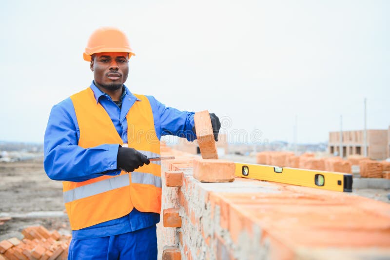Portrait of an African American Construction Worker. a Builder Builds a ...