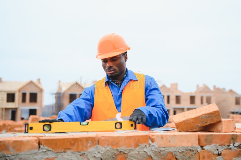 Portrait of an African American Construction Worker. a Builder Builds a ...