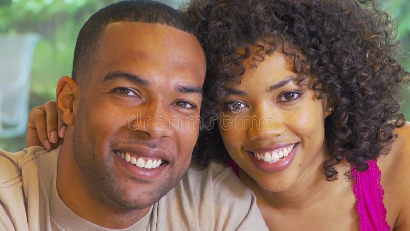 An African American Man and Woman Cuddle and Pose for a Portrait on the ...