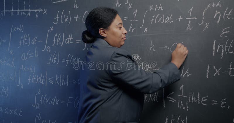 Portrait of African American Maths Teacher Writing on Chalk Board and ...