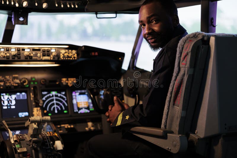 Portrait of African American Pilot Using Dashboard Command in Cabin ...