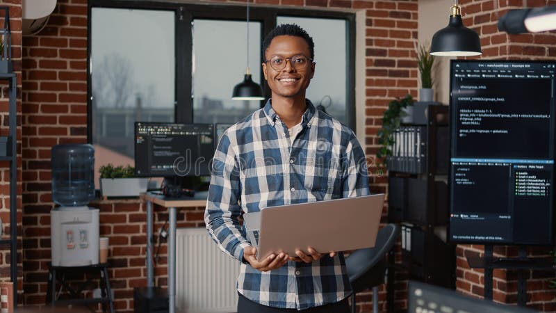 Portrait of African American Programer Standing Working on Laptop ...