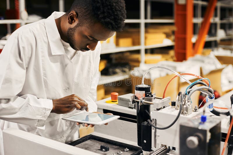 African Engineer Programming Equipment with Tablet at Factory Stock ...