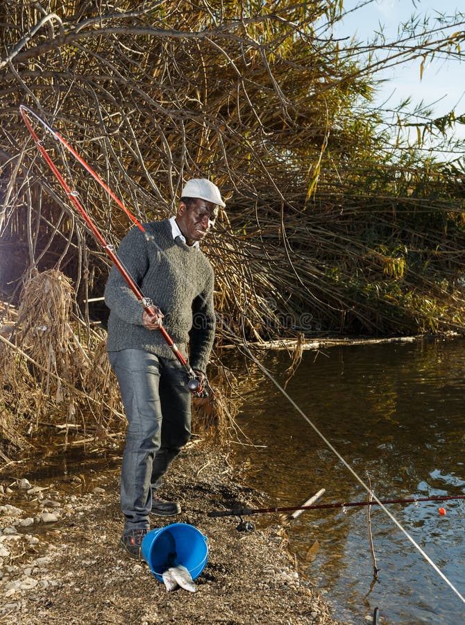 Afro Fisherman Pulling Fish Stock Image - Image of leisure, pulling ...