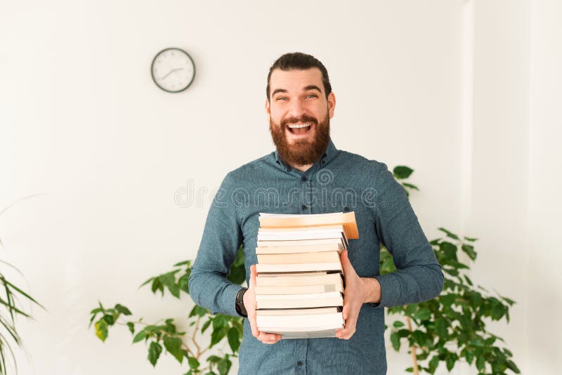 Portrait of Amazed Office Worker Man Holding a Bunch of Books Stock ...