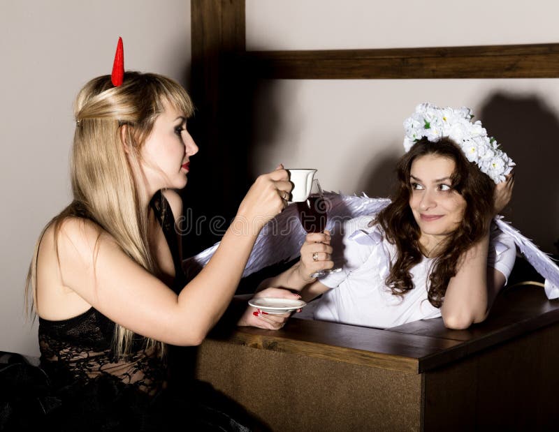 Portrait of Angel and Devil Womans Drink Coffee Nad Wine Stock Image ...