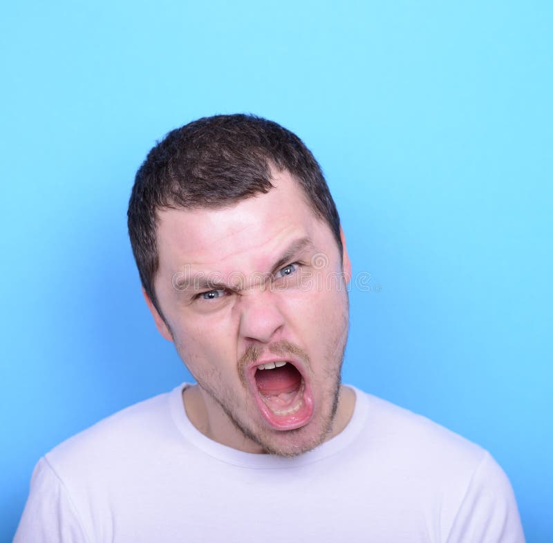 Portrait of Angry Man Screaming and Pulling Hair Against Blue Ba Stock ...