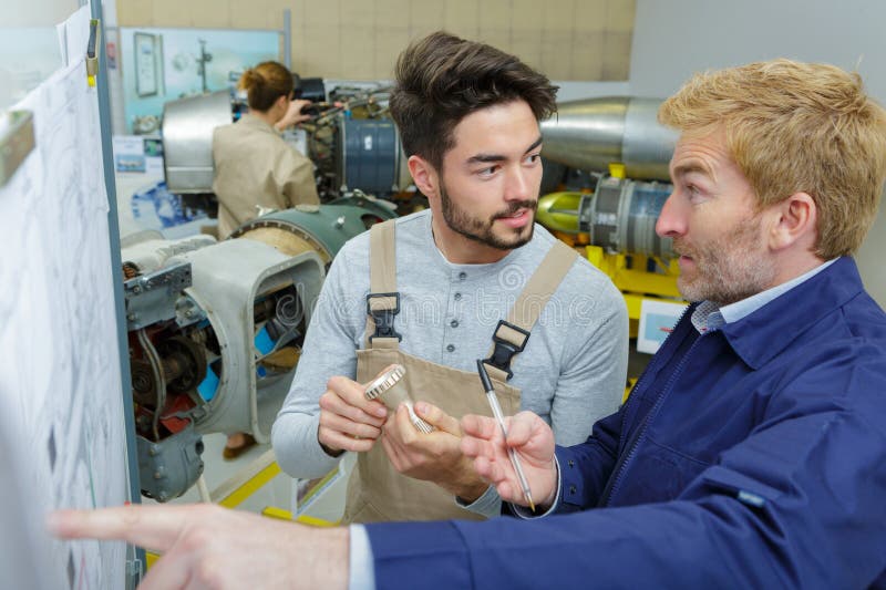 Portrait Apprentice Talking To Engineer Stock Photo - Image of wall ...