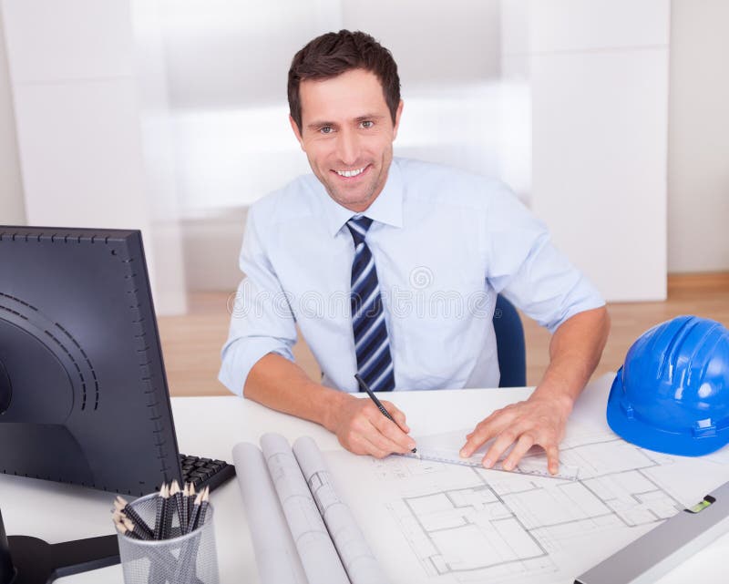 Male Architect with Digital Tablet Studying Plans in Office Stock Photo ...