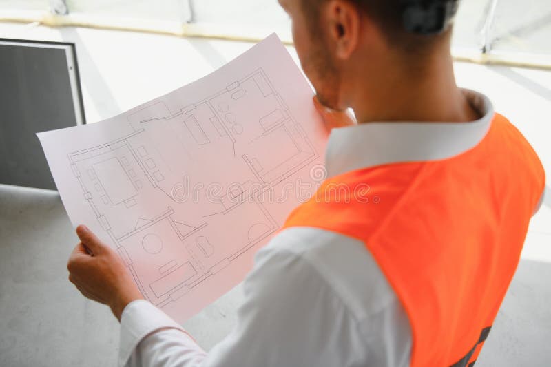Portrait of an Architect Builder Studying Layout Plan of the Rooms ...