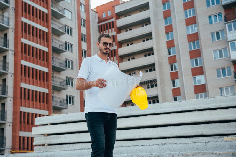 Portrait of an Architect Builder Studying Layout Plan of the Rooms ...
