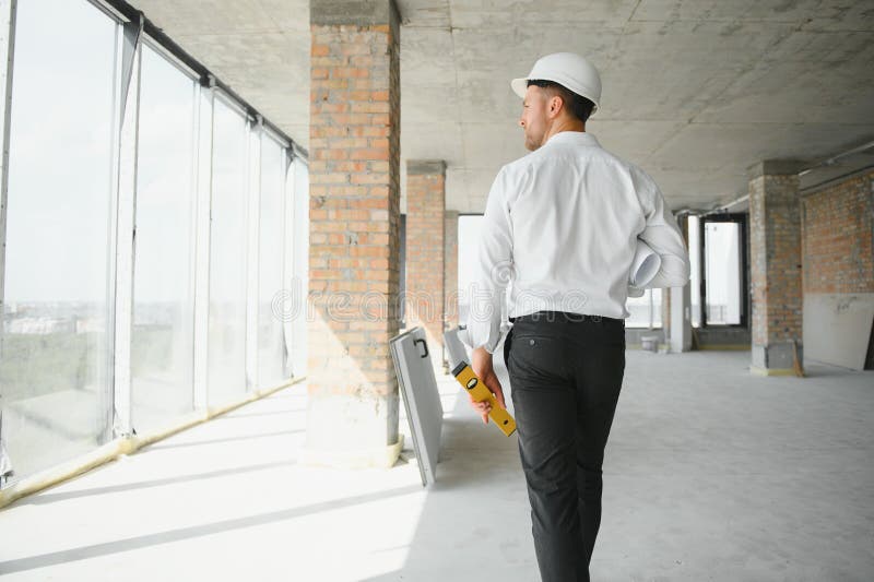 Portrait of an Architect Builder Studying Layout Plan of the Rooms ...