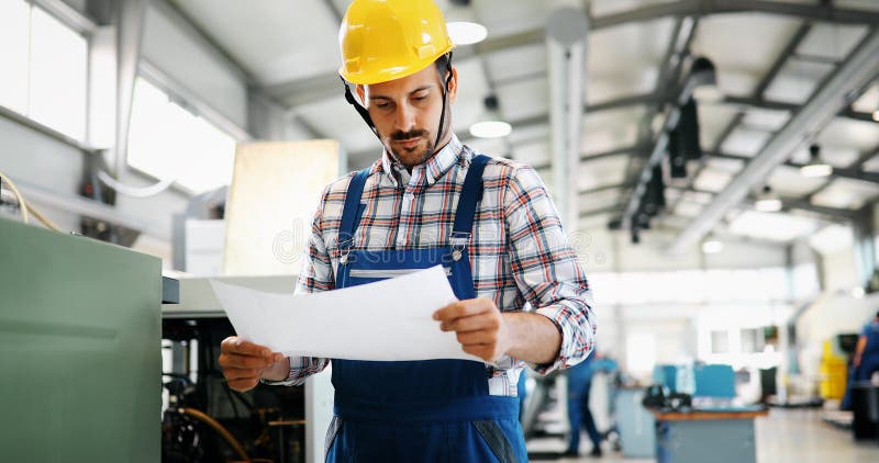 Portrait of an Architect Builder Studying Layout Plans of Plant Stock ... Portrait of an Architect Builder Studying Layout Plans of Plant Stock ...