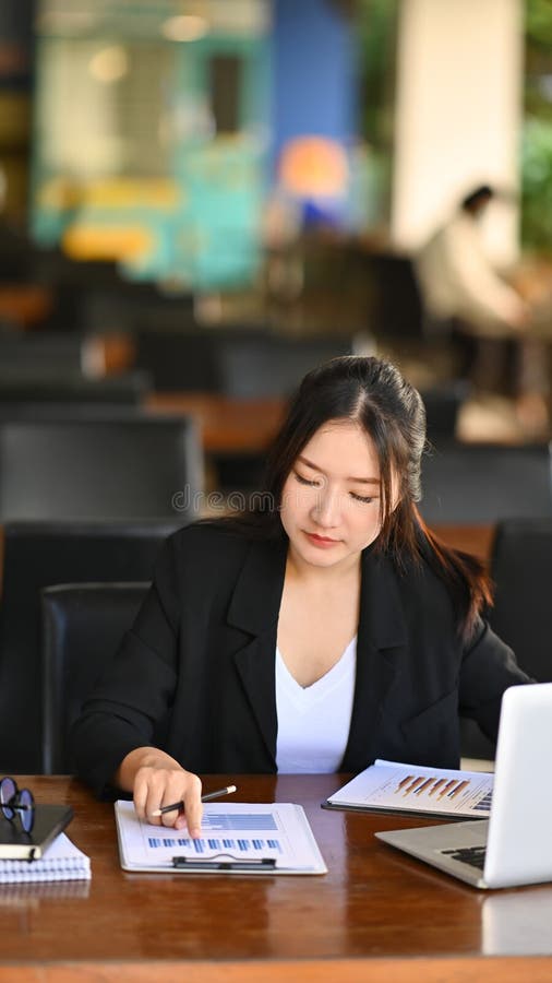 Asian Businesswoman Analyzing Business Graph at Office Desk. Stock ... Asian Businesswoman Analyzing Business Graph at Office Desk. Stock ...